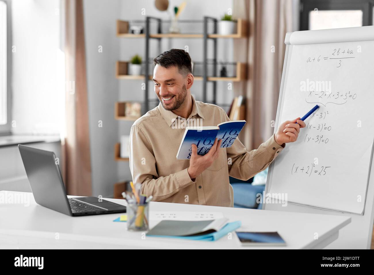 math teacher with laptop has online class at home Stock Photo - Alamy