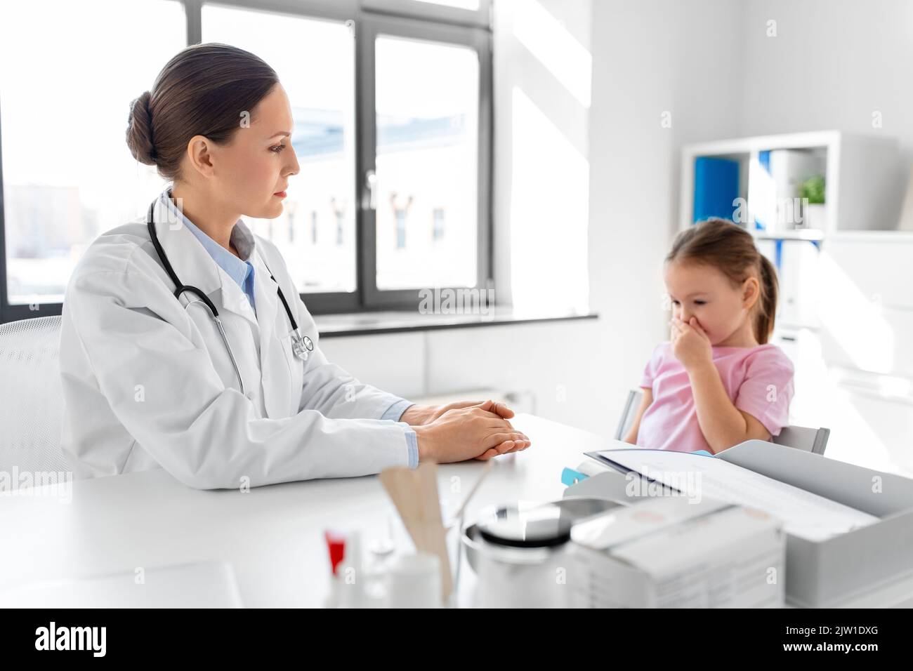 doctor and little girl patient coughing at clinic Stock Photo - Alamy