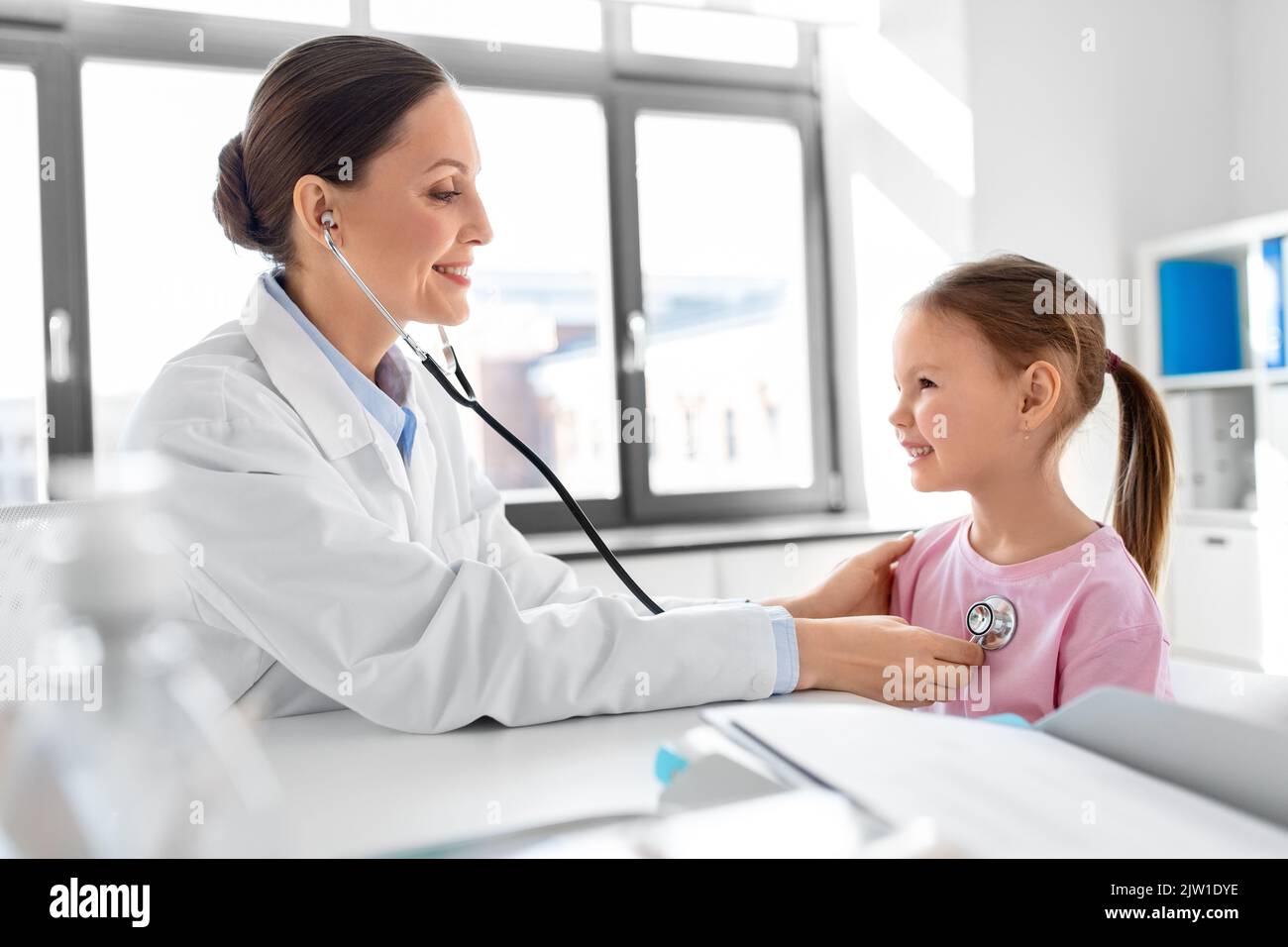 doctor with stethoscope and girl patient at clinic Stock Photo - Alamy