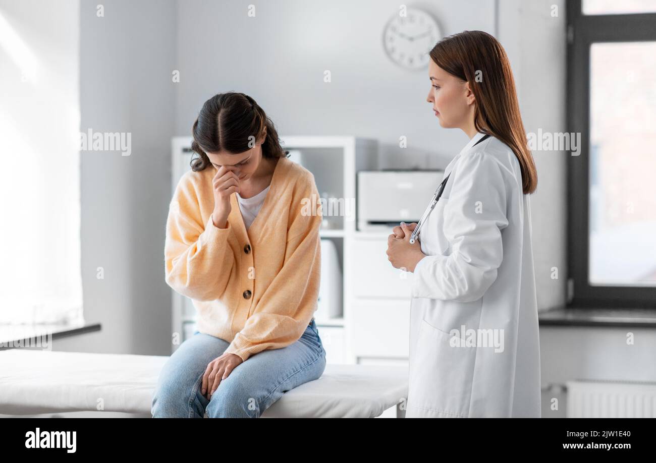 female doctor talking to sad woman at hospital Stock Photo - Alamy