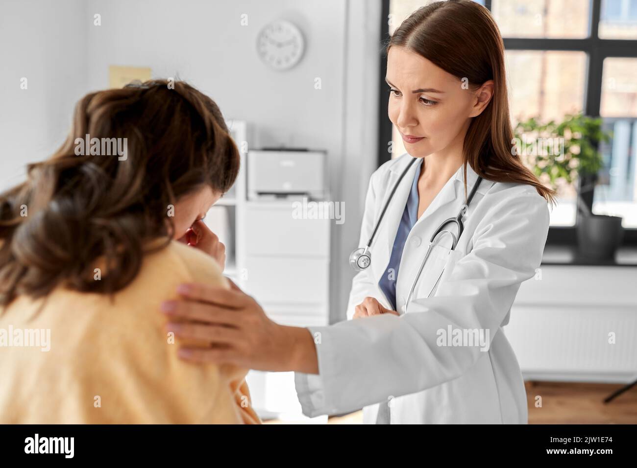 female doctor comforting sad woman at hospital Stock Photo - Alamy