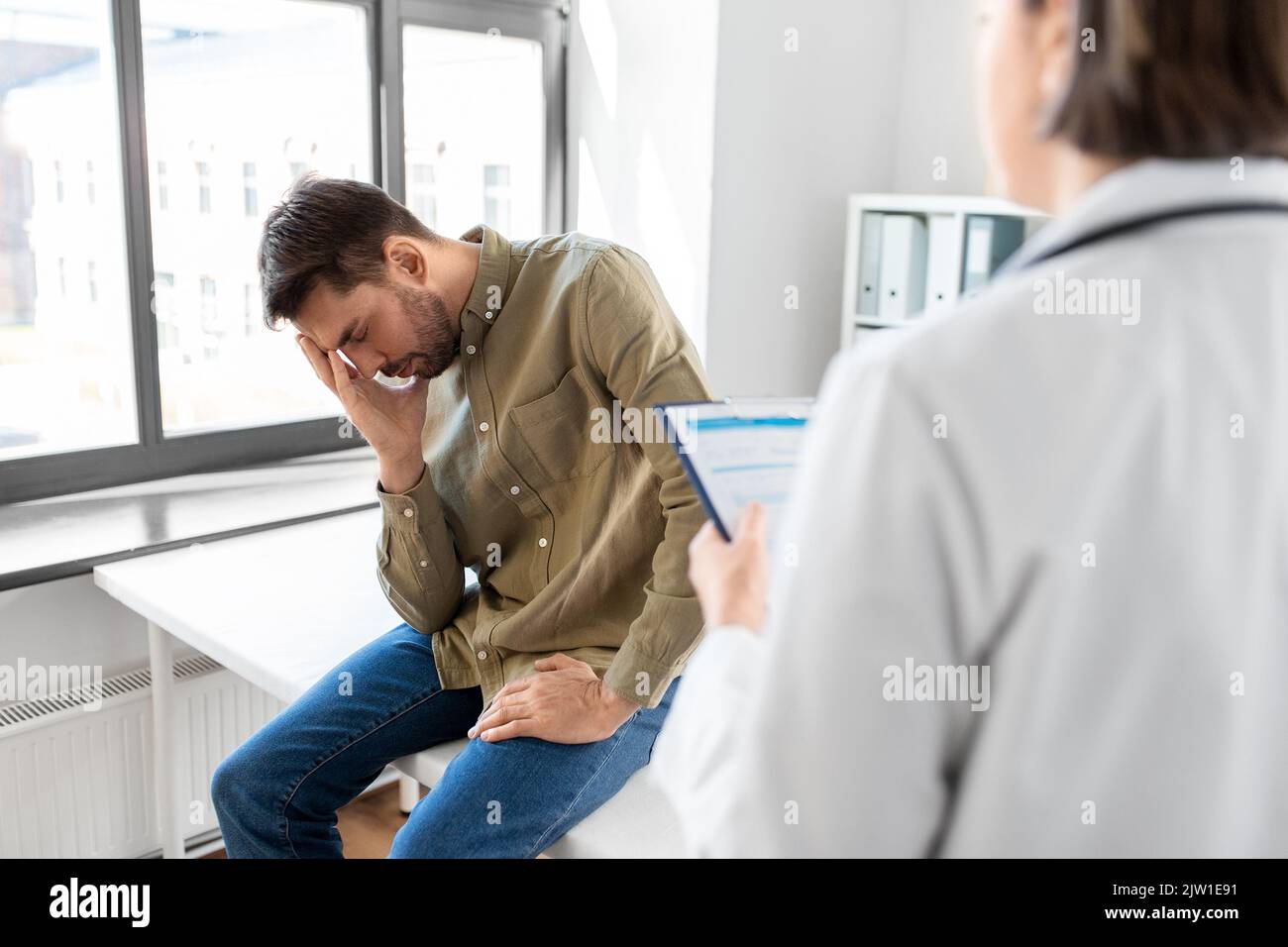 Sad female doctor headache hi-res stock photography and images - Alamy