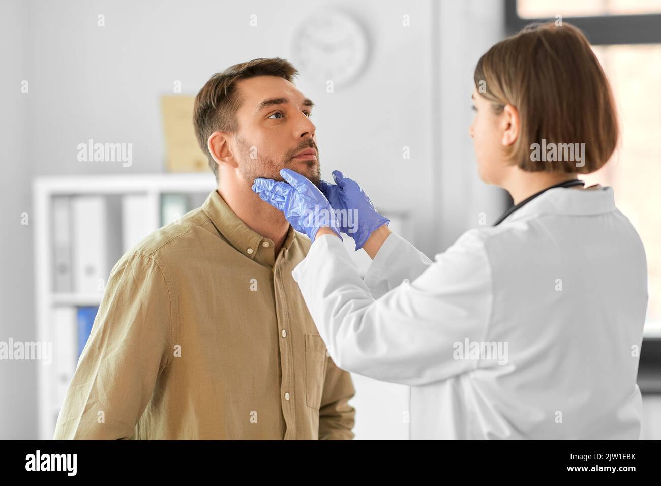 doctor checking lymph nodes of man at hospital Stock Photo - Alamy