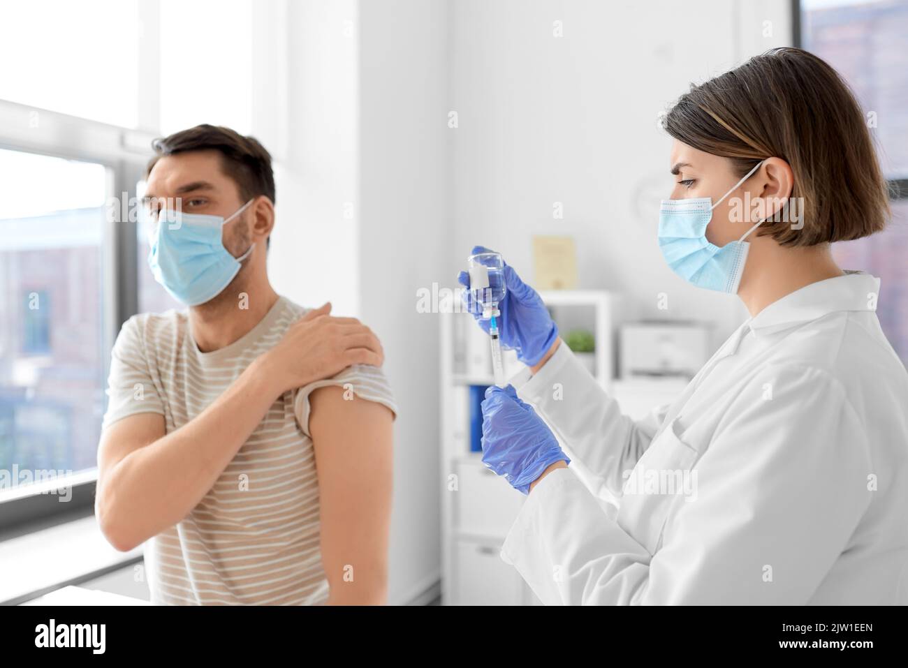 doctor with syringe vaccinating male patient Stock Photo - Alamy