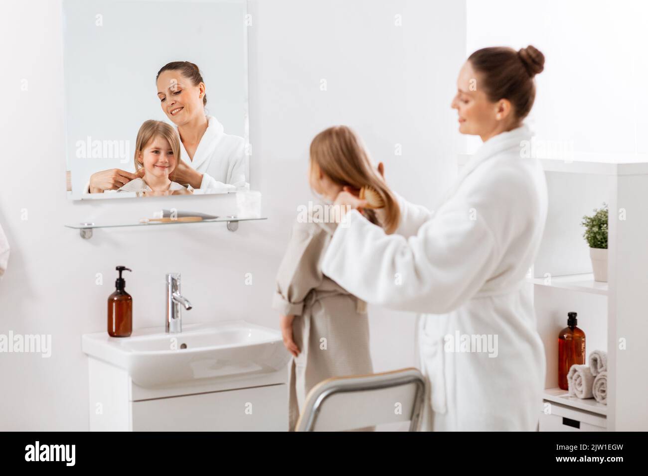 mother and daughter brushing hair at bathroom Stock Photo - Alamy