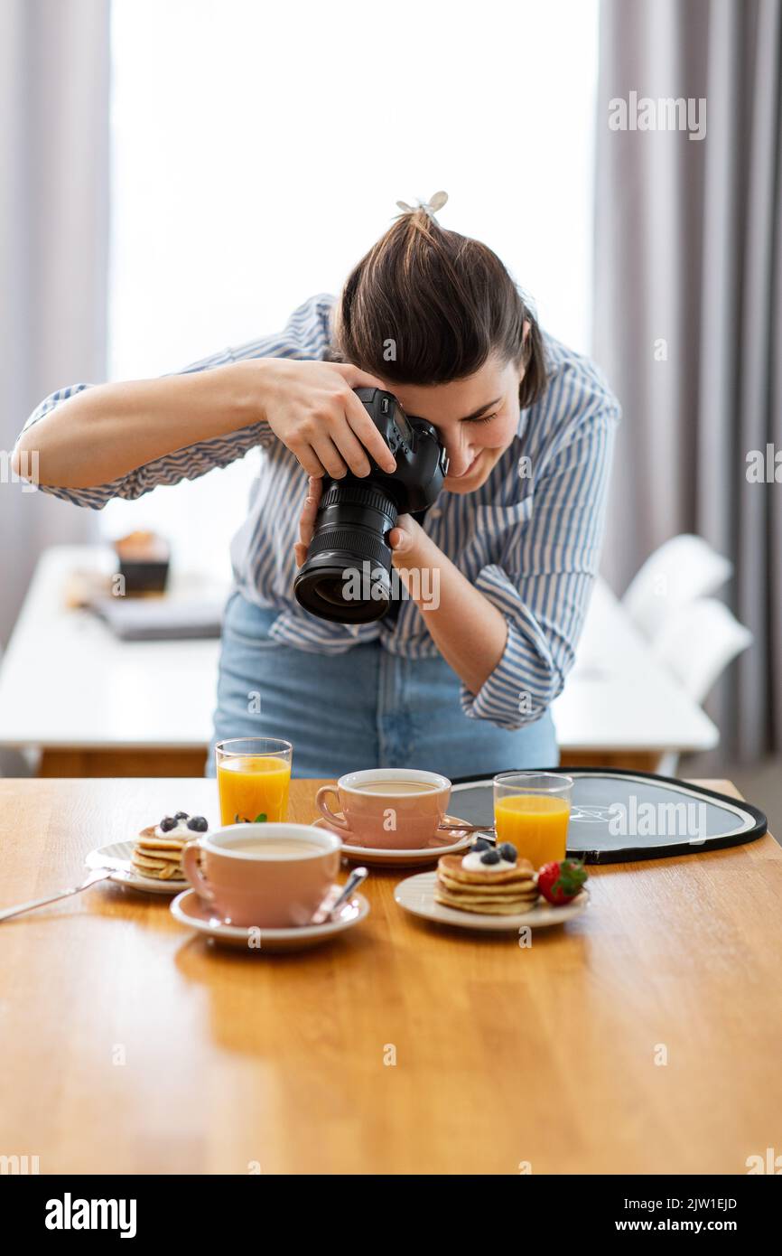 food photographer with camera working in kitchen Stock Photo - Alamy