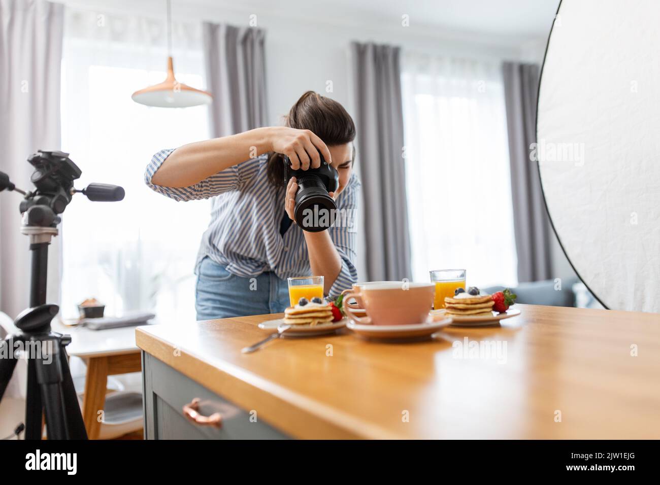 food photographer with camera working in kitchen Stock Photo - Alamy
