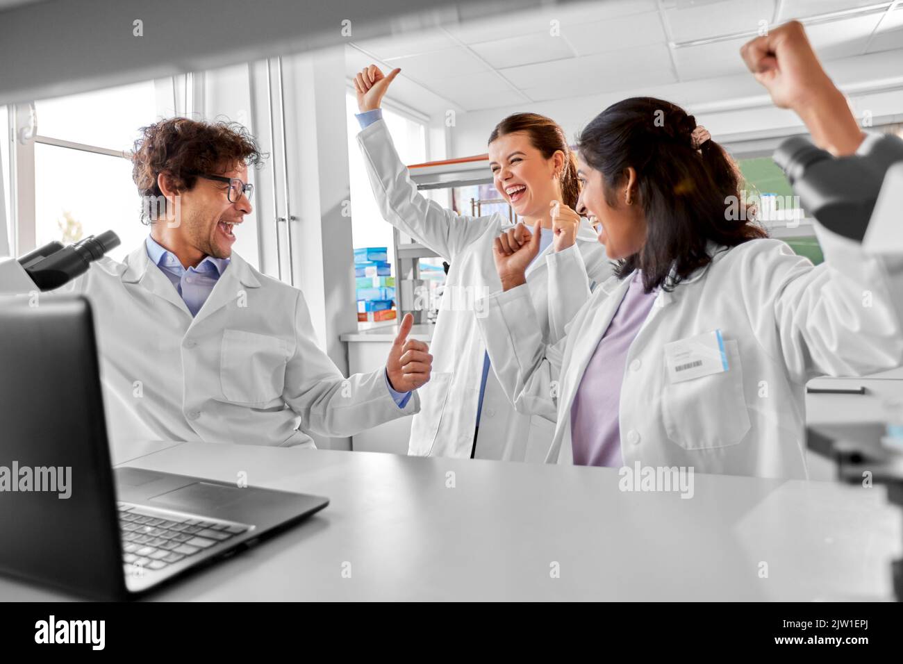happy group of scientists working in laboratory Stock Photo - Alamy