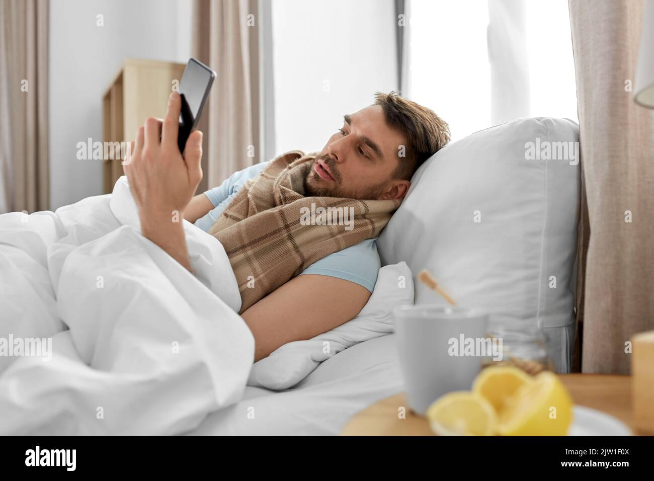 Sick in bed phone hi-res stock photography and images - Alamy
