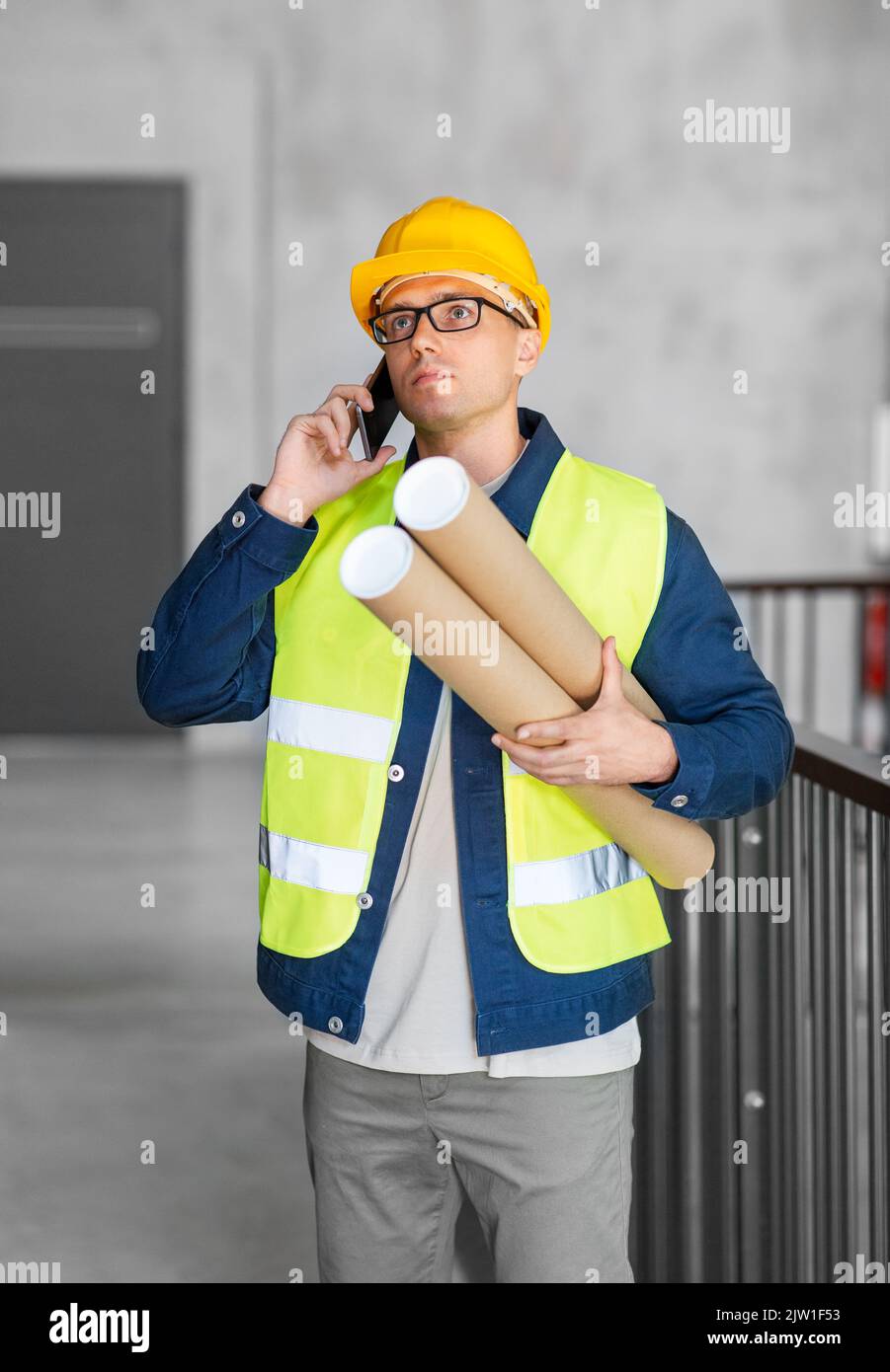 male architect with blueprint calling on phone Stock Photo - Alamy