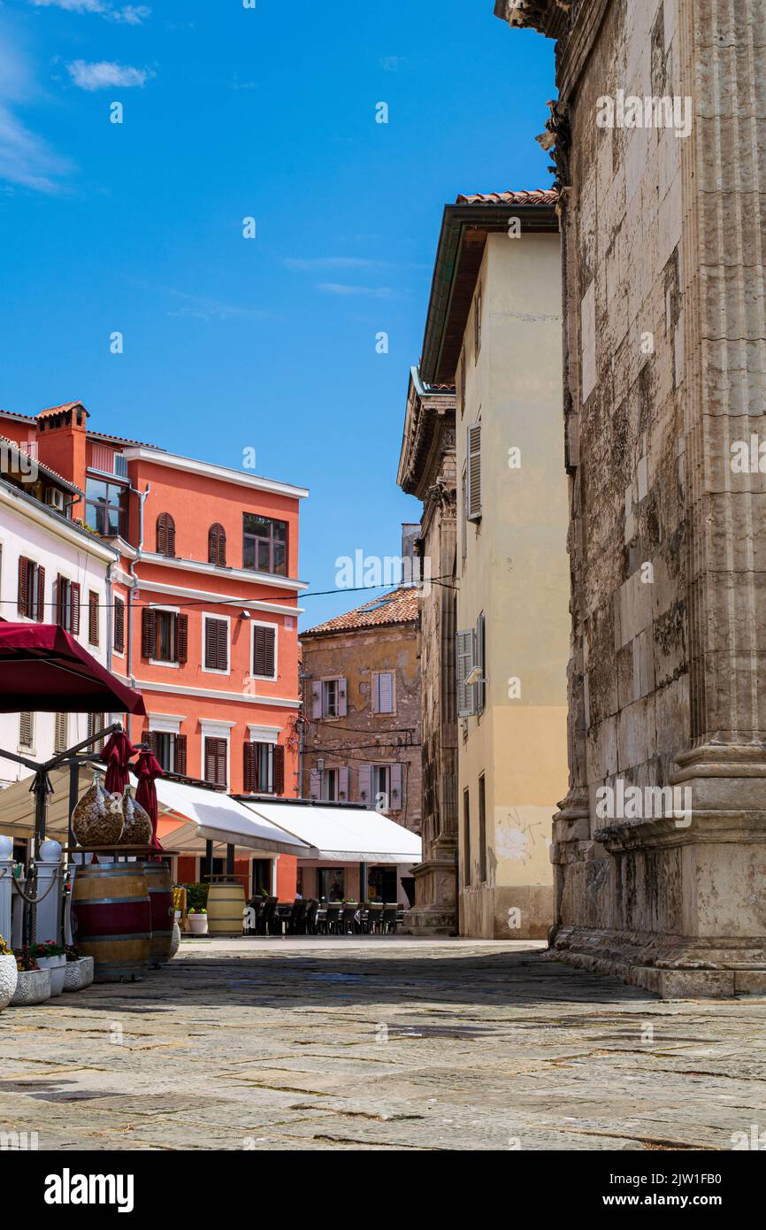 Colorful buildings and trappings of restaurants along a side street ...