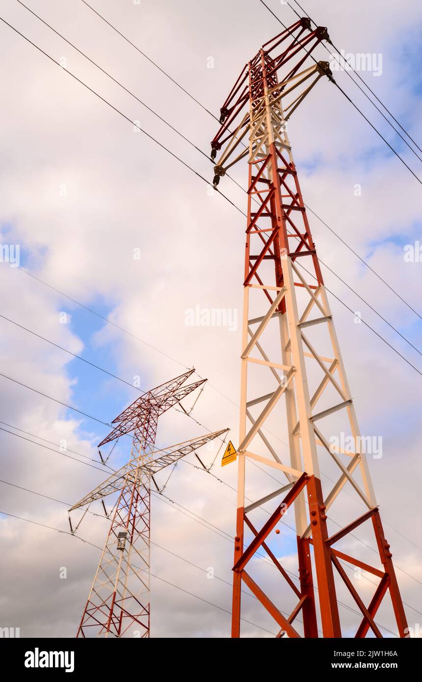 A low angle shot of high-voltage electric transmission towers under a ...