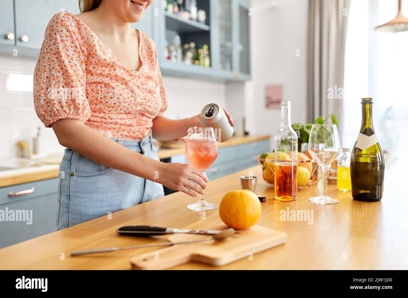 Young woman drinks orange soda hi-res stock photography and images - Alamy
