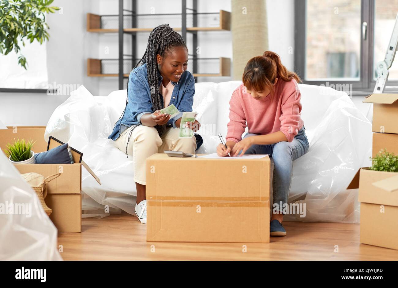 women moving to new home and counting money Stock Photo - Alamy