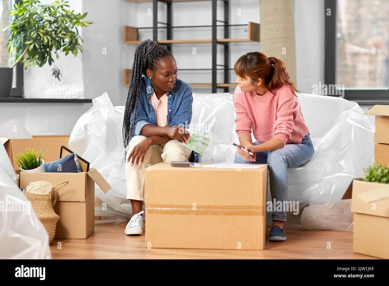 women moving to new home and counting money Stock Photo - Alamy