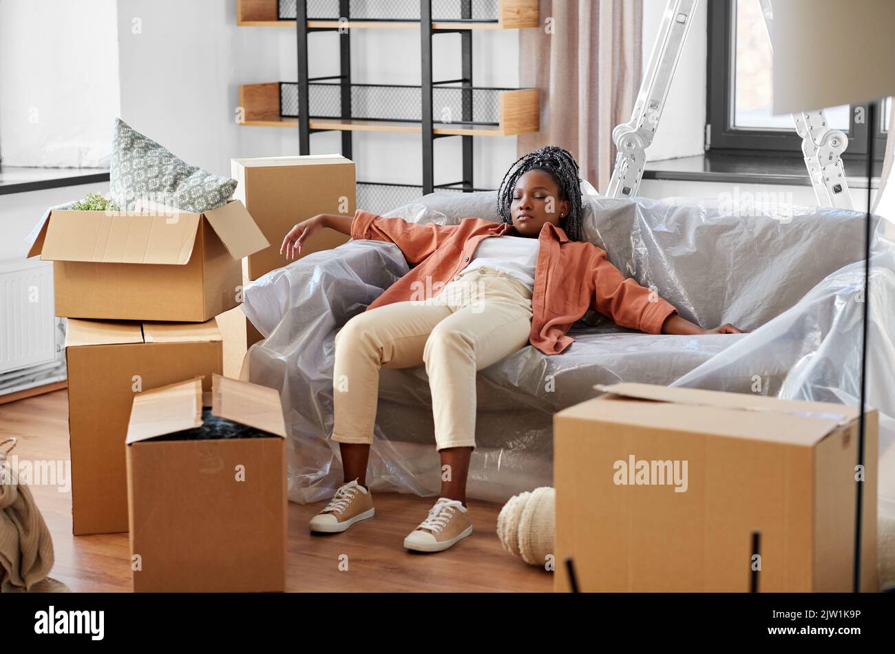 tired woman sleeping on sofa moving to new home Stock Photo - Alamy