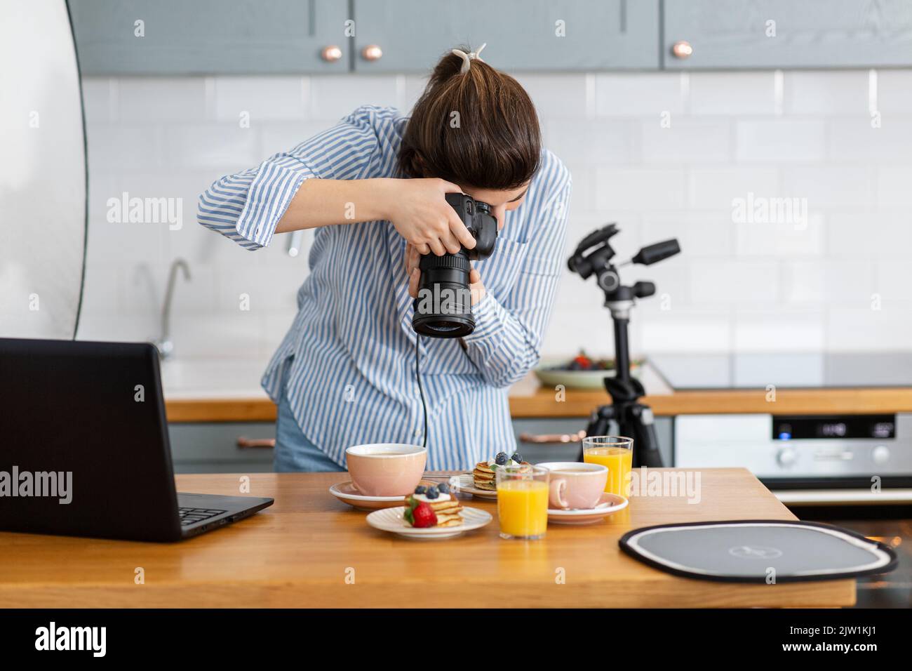 food photographer with camera working in kitchen Stock Photo - Alamy