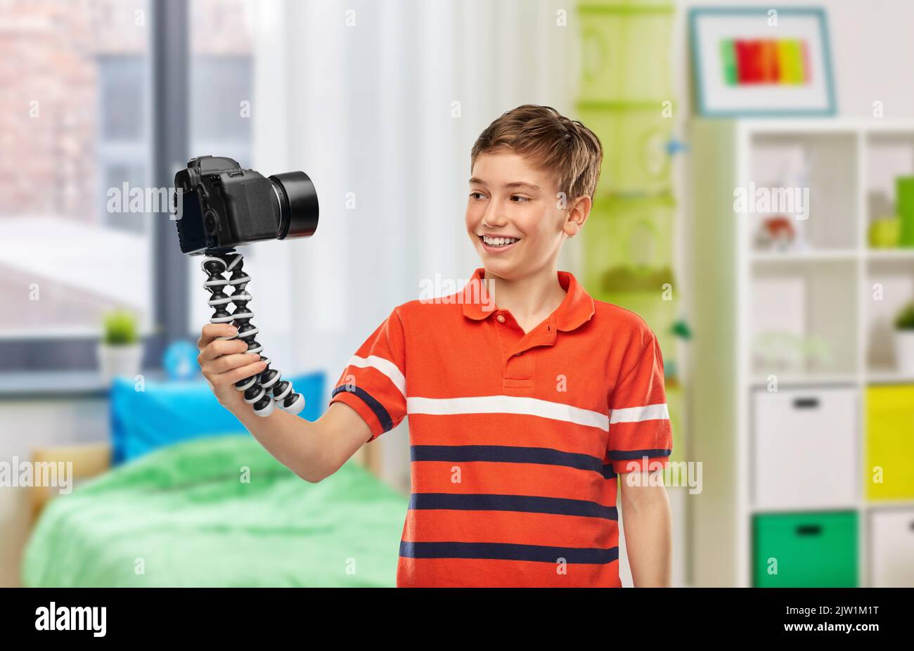 boy video blogger with camera and tripod at home Stock Photo - Alamy