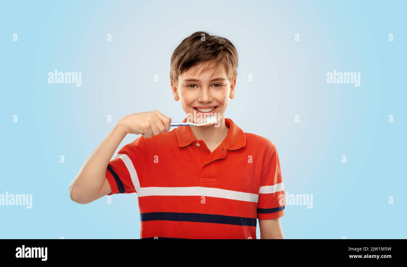 happy boy brushing teeth with toothbrush Stock Photo - Alamy