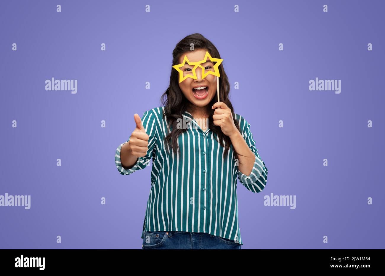 happy woman with party glasses showing thumbs up Stock Photo - Alamy