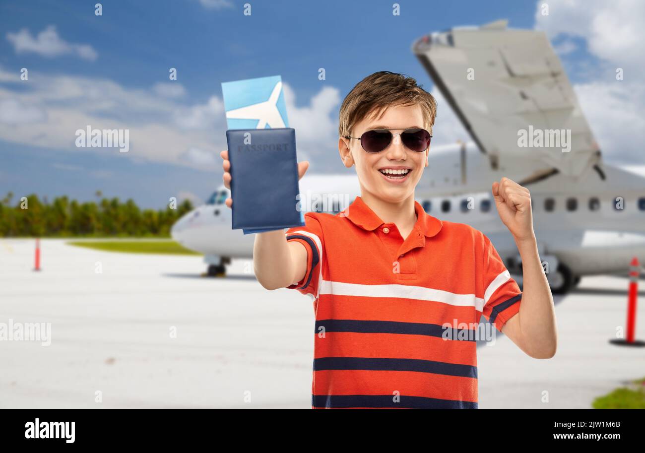 happy boy with air ticket and passport on airfield Stock Photo - Alamy
