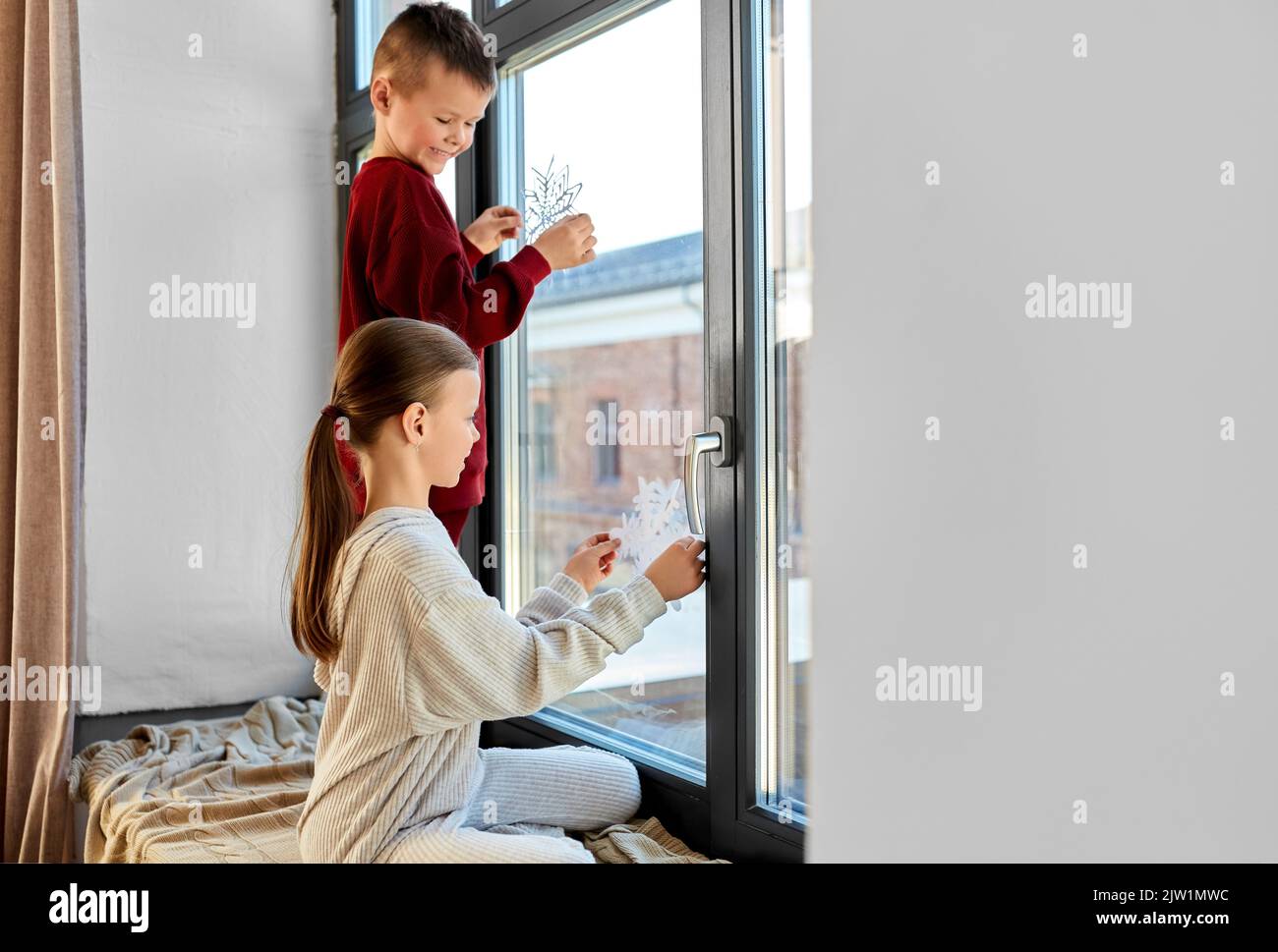happy children decorating window on christmas Stock Photo - Alamy