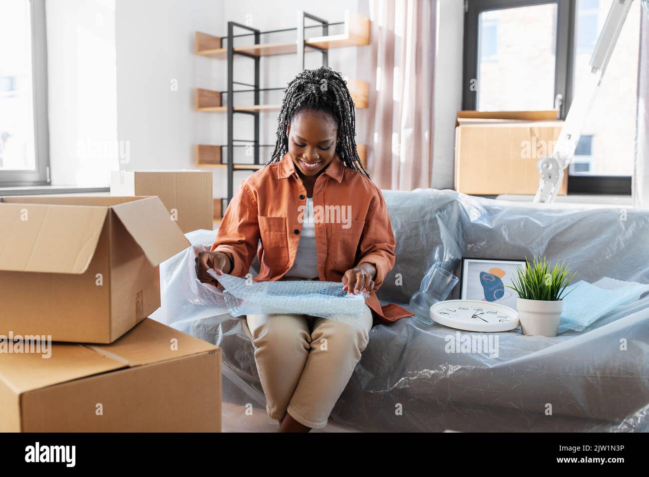 Happy woman packing boxes hi-res stock photography and images - Alamy