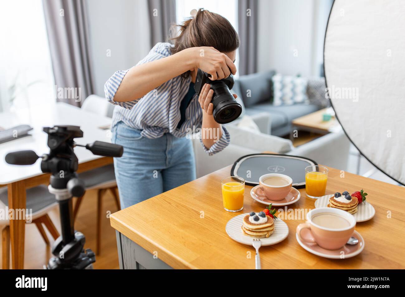 food photographer with camera working in kitchen Stock Photo - Alamy