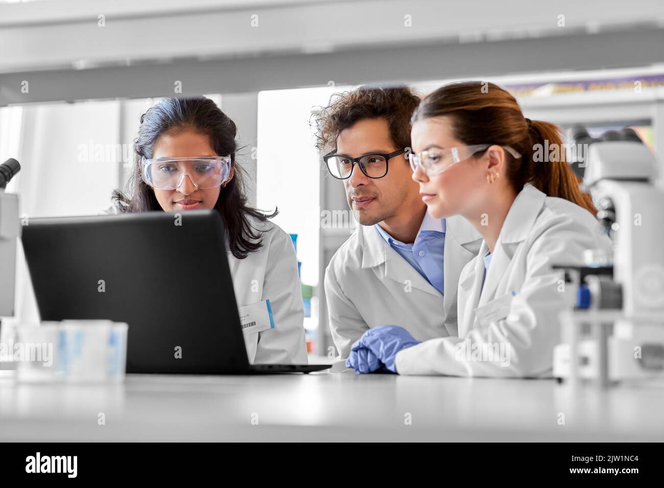 scientists with laptop working in laboratory Stock Photo - Alamy
