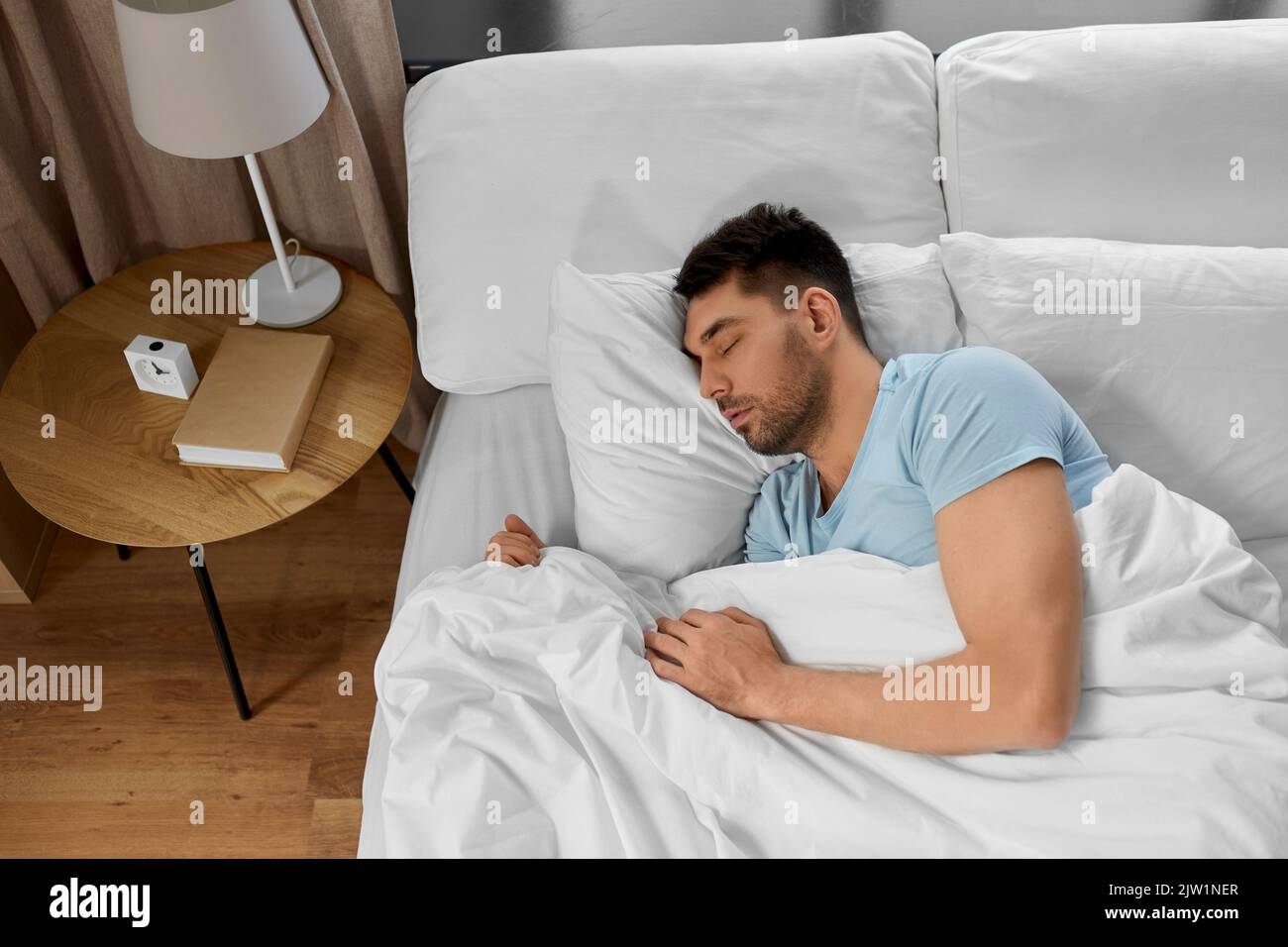man sleeping in bed at home Stock Photo - Alamy