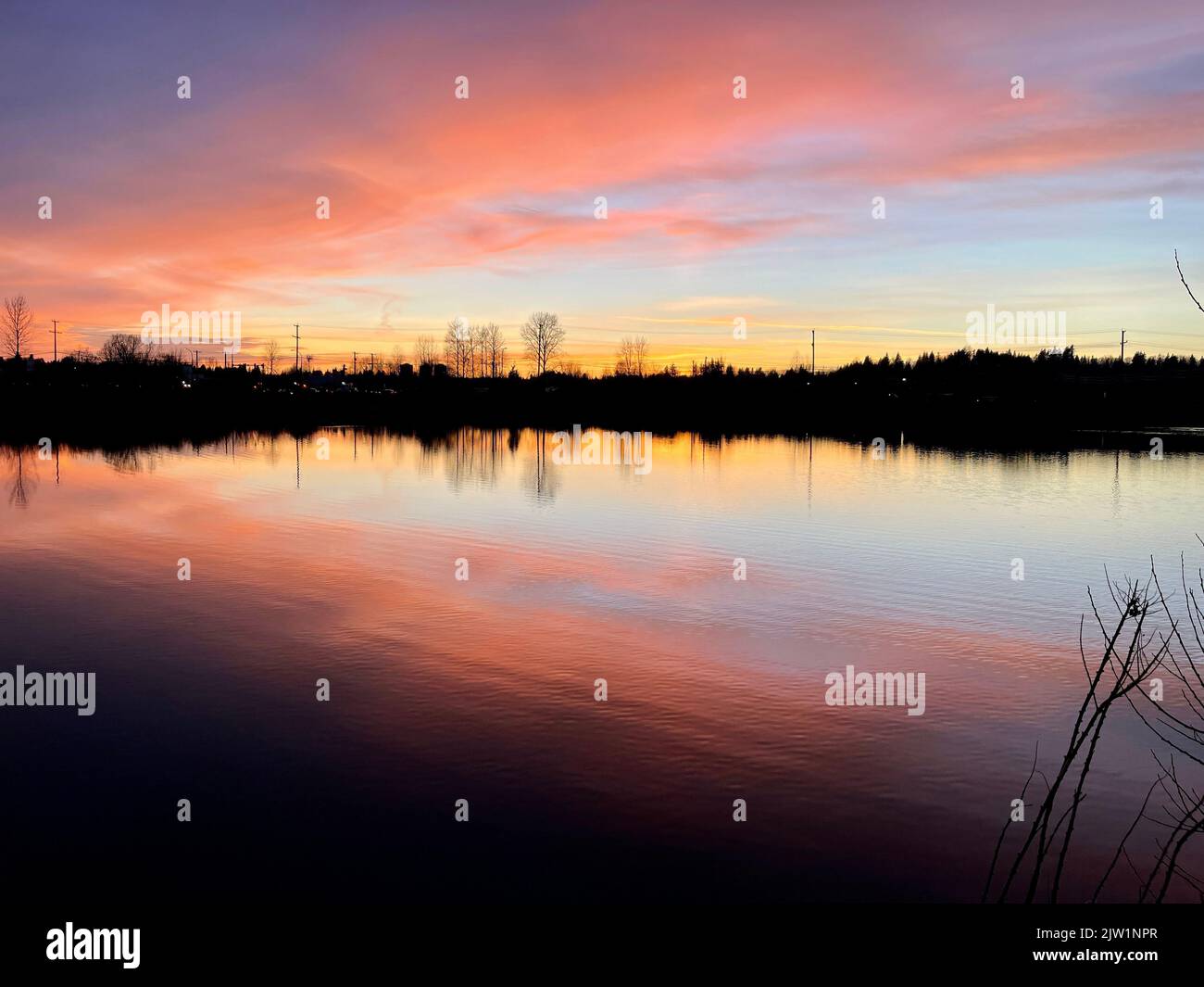 The pastel-colored sunset sky reflected in a lake Stock Photo - Alamy