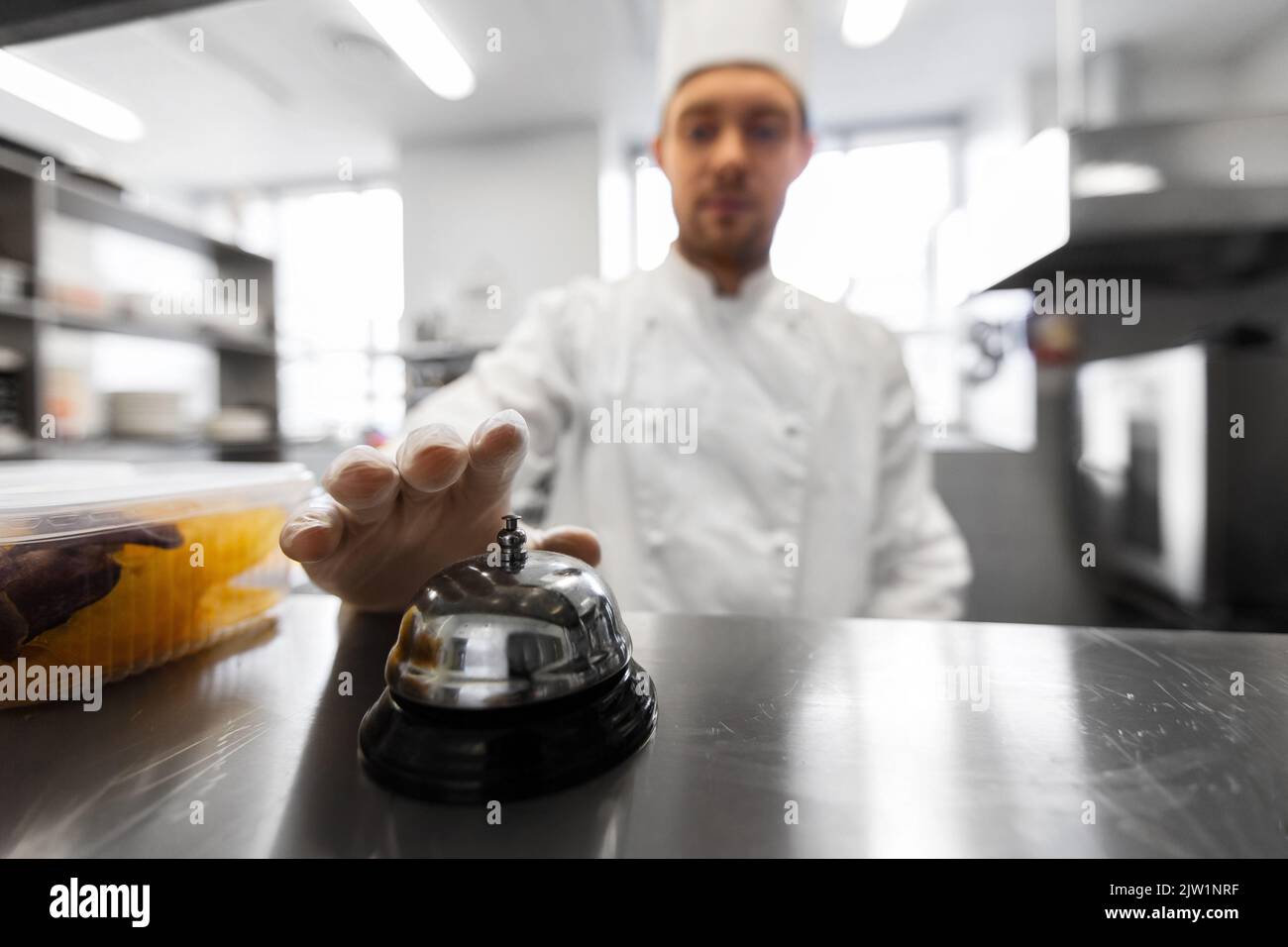 close up of chef ringing bell at restaurant Stock Photo - Alamy