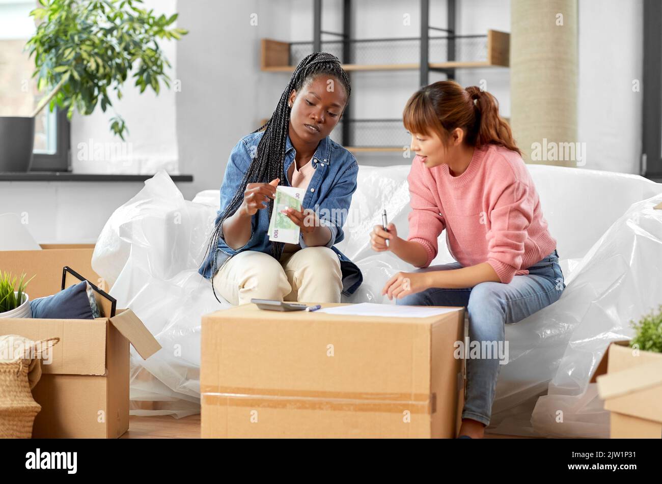 women moving to new home and counting money Stock Photo - Alamy