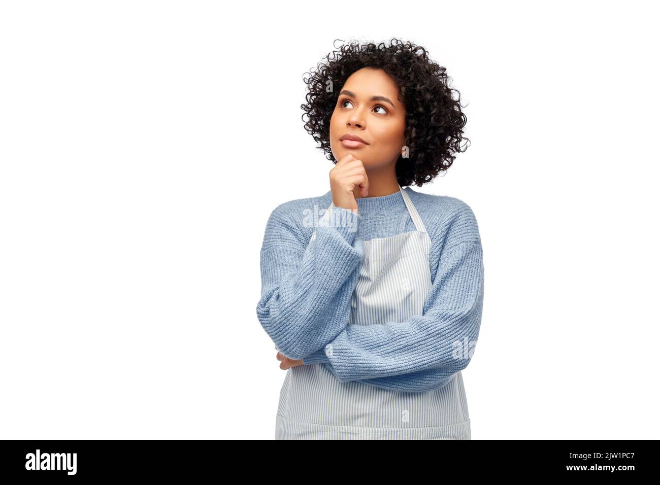dreaming woman in apron over white background Stock Photo - Alamy