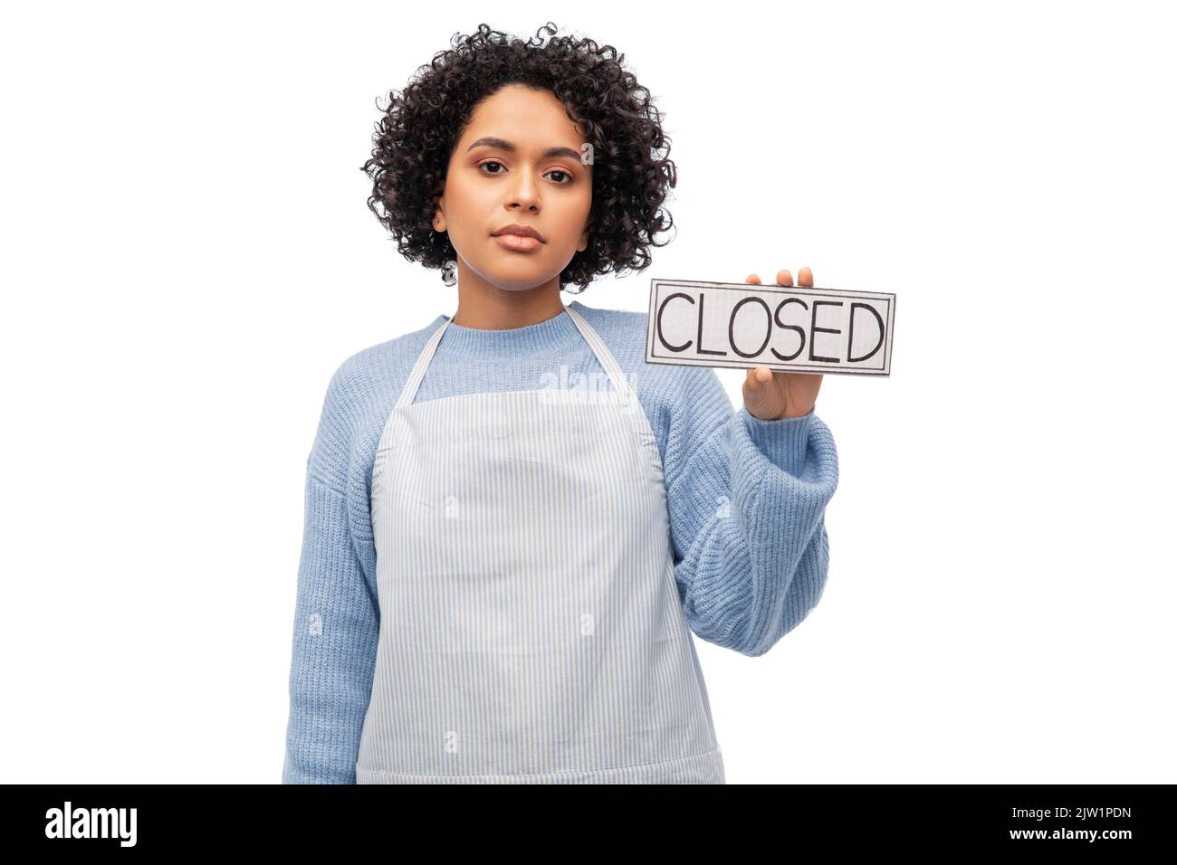 woman in apron holding closed sign Stock Photo - Alamy