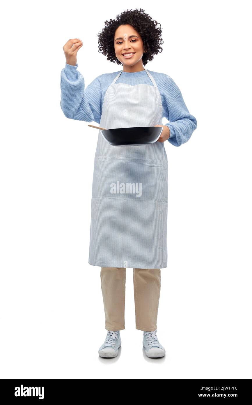happy woman in apron cooking food in frying pan Stock Photo - Alamy