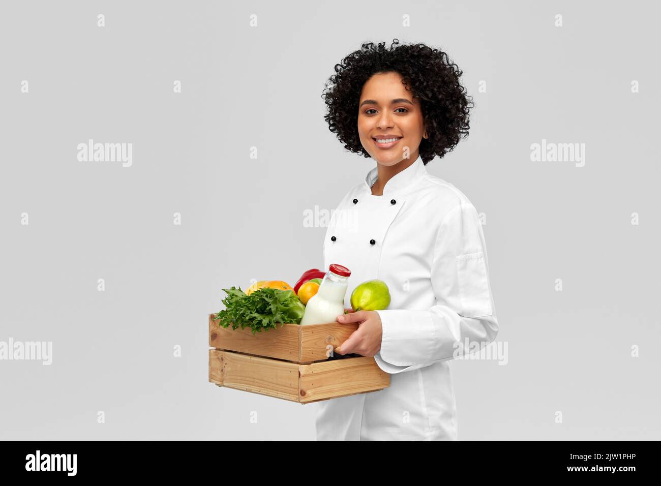 happy smiling female chef with food in wooden box Stock Photo - Alamy