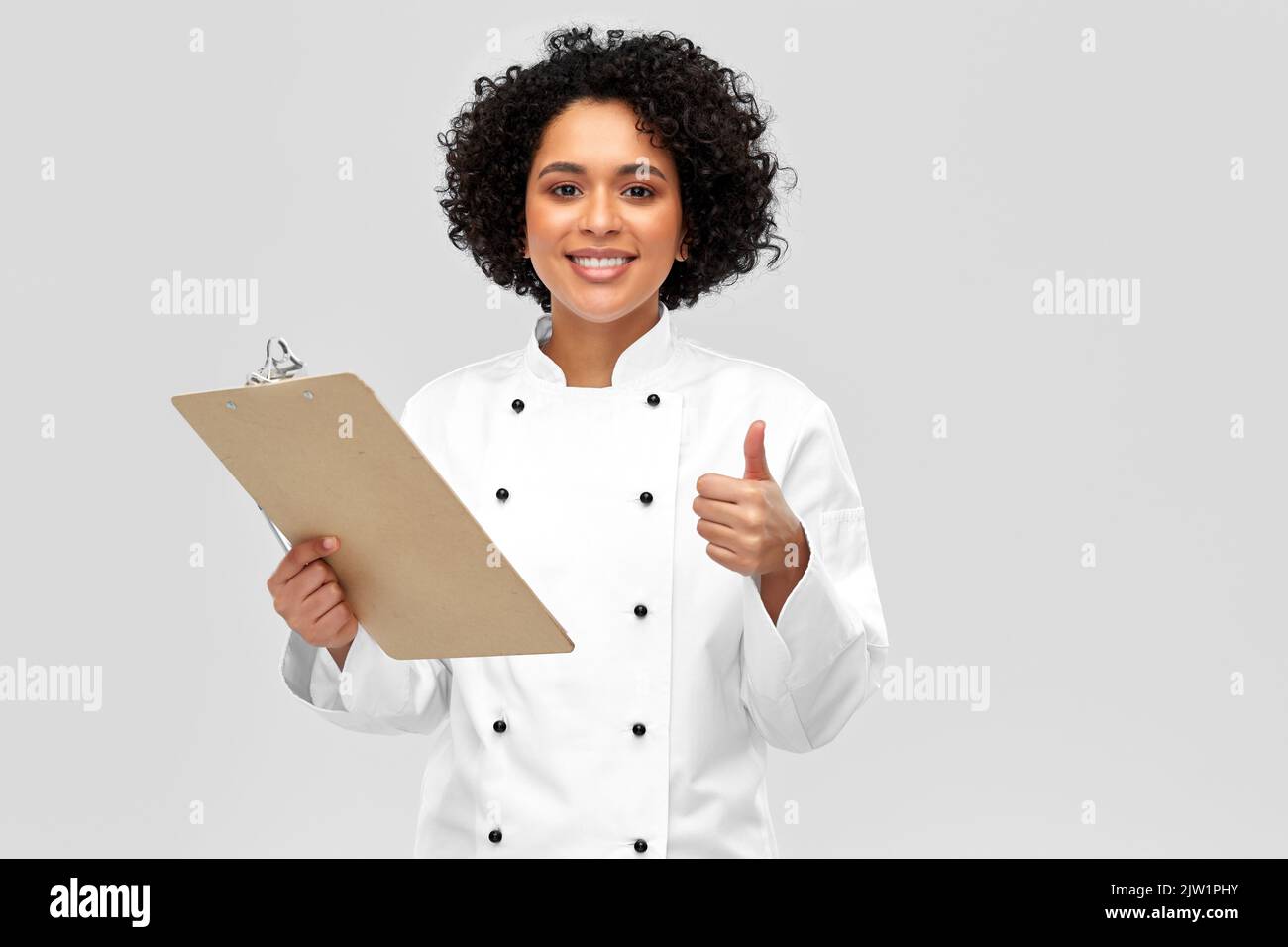 happy female chef with clipboard showing thumbs up Stock Photo - Alamy