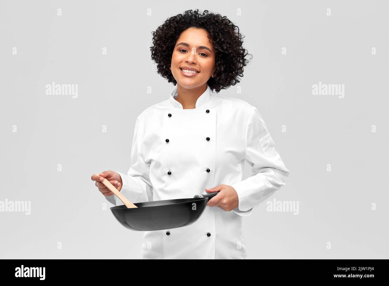 smiling female chef with frying pan Stock Photo - Alamy