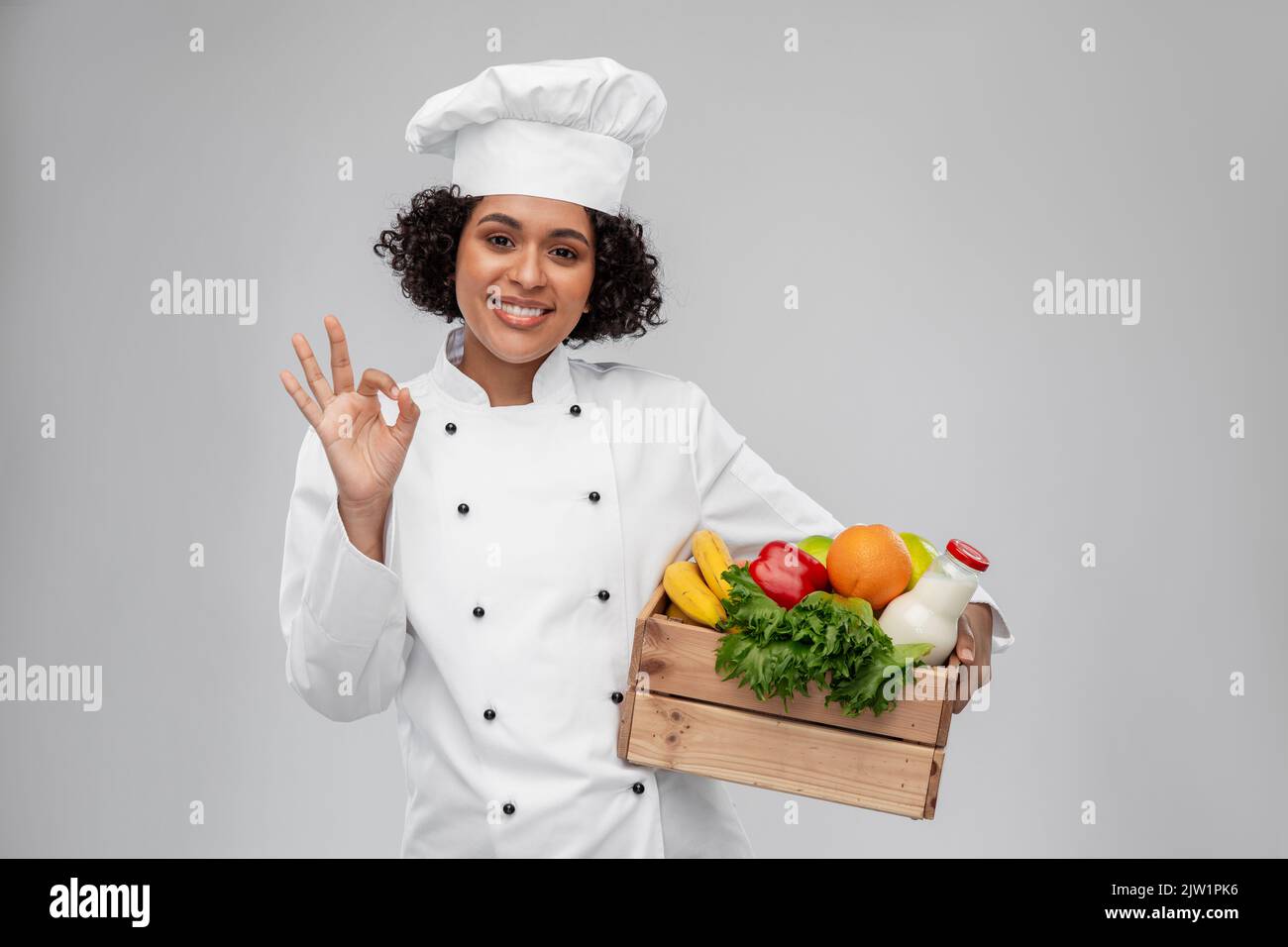 happy smiling female chef with food in wooden box Stock Photo - Alamy