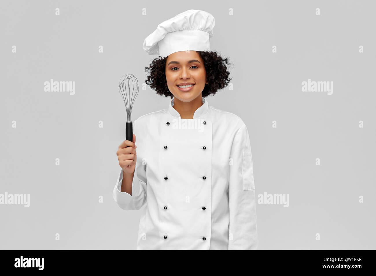 happy female chef with whisk over grey background Stock Photo - Alamy