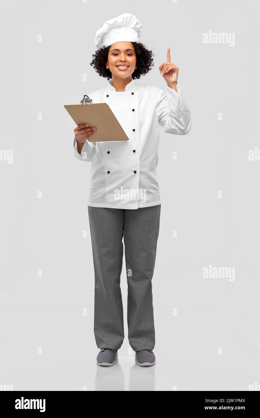 female chef with clipboard showing thumbs up Stock Photo - Alamy
