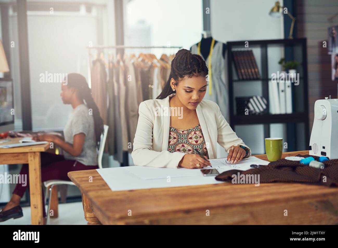 Paying attention to every detail. a successful young fashion designer ...