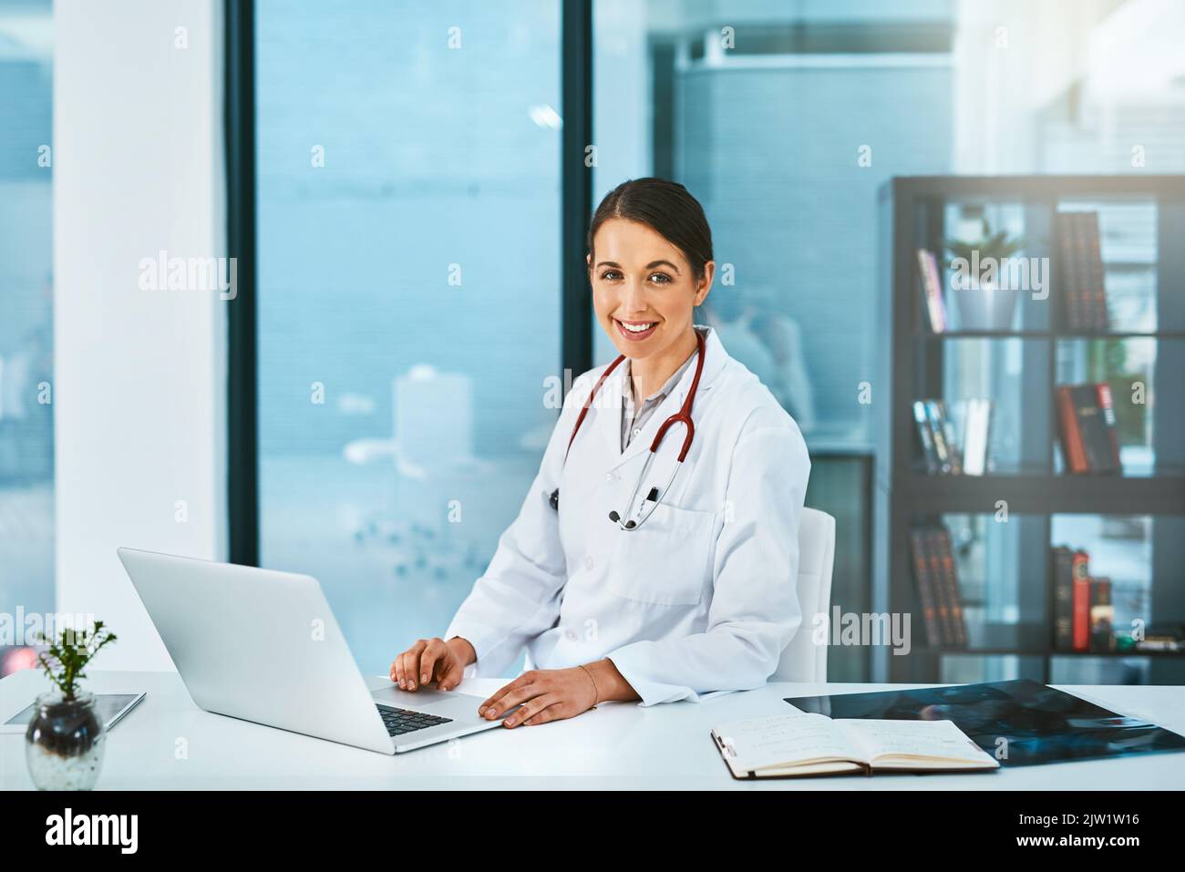 Medical care is a passion. Portrait of a young doctor working on a ...