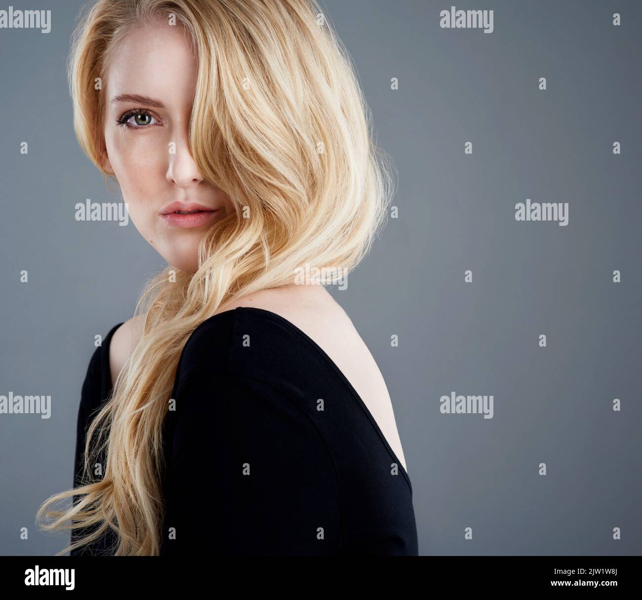 Gorgeously golden tresses. Studio portrait of an attractive young woman ...