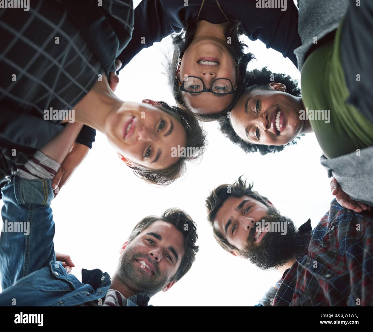 Happy to put their heads together. a group of creative businesspeople ...