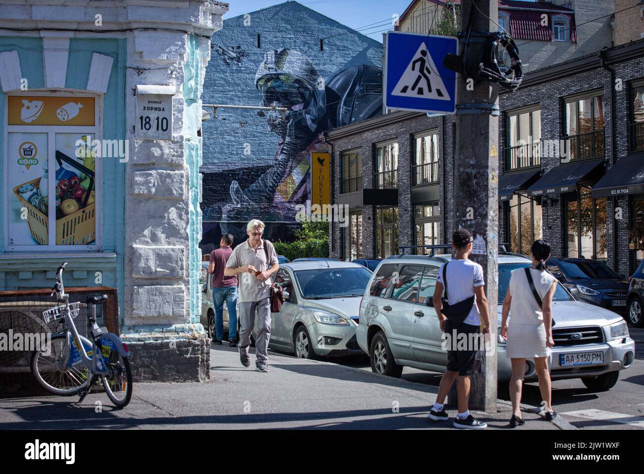 Kyiv, Ukraine. 30th Aug, 2022. People walk near the mural "Ghost of ...