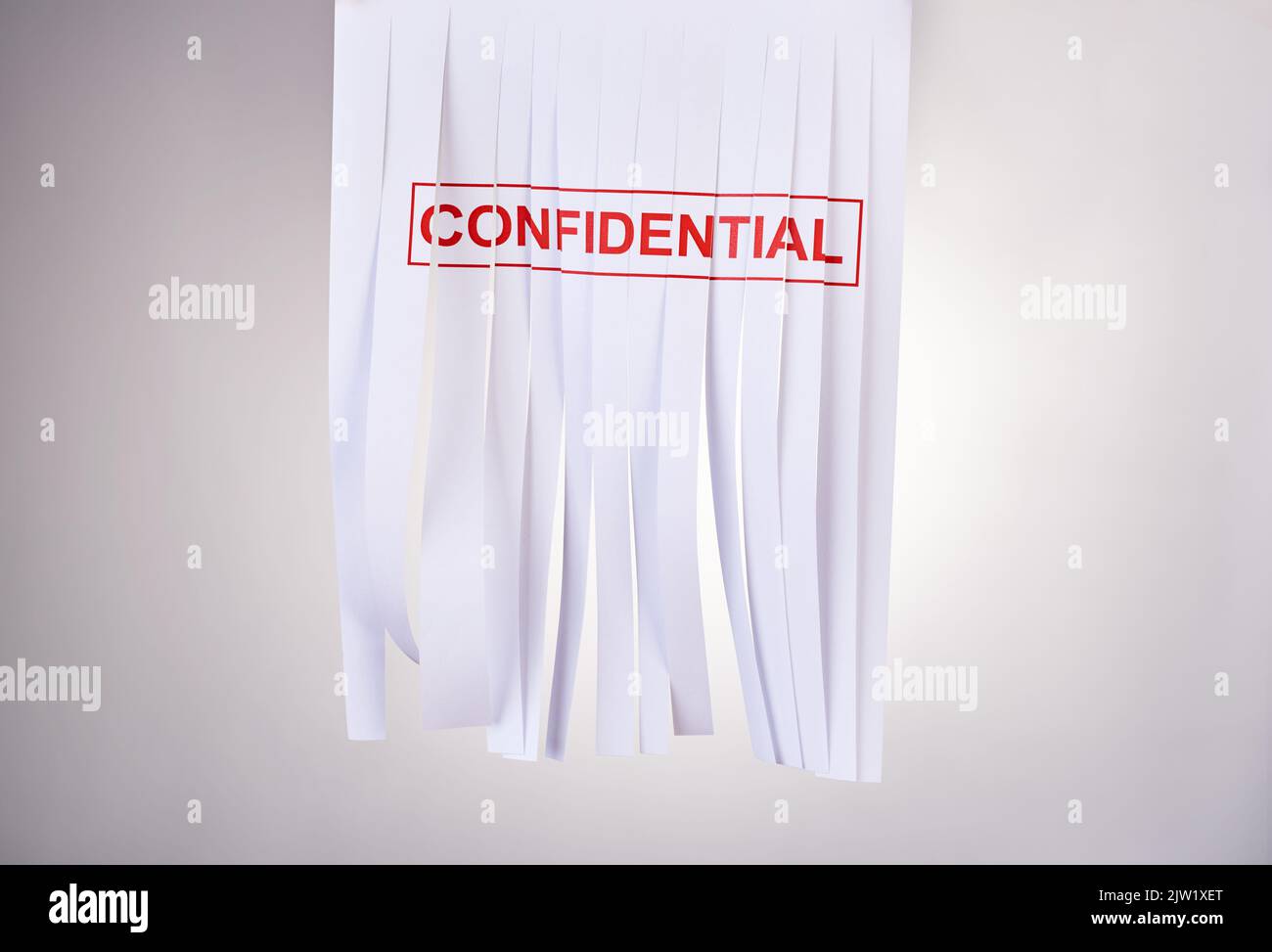 Confidentiality intact. Studio shot of a sheet of shredded paper Stock ...