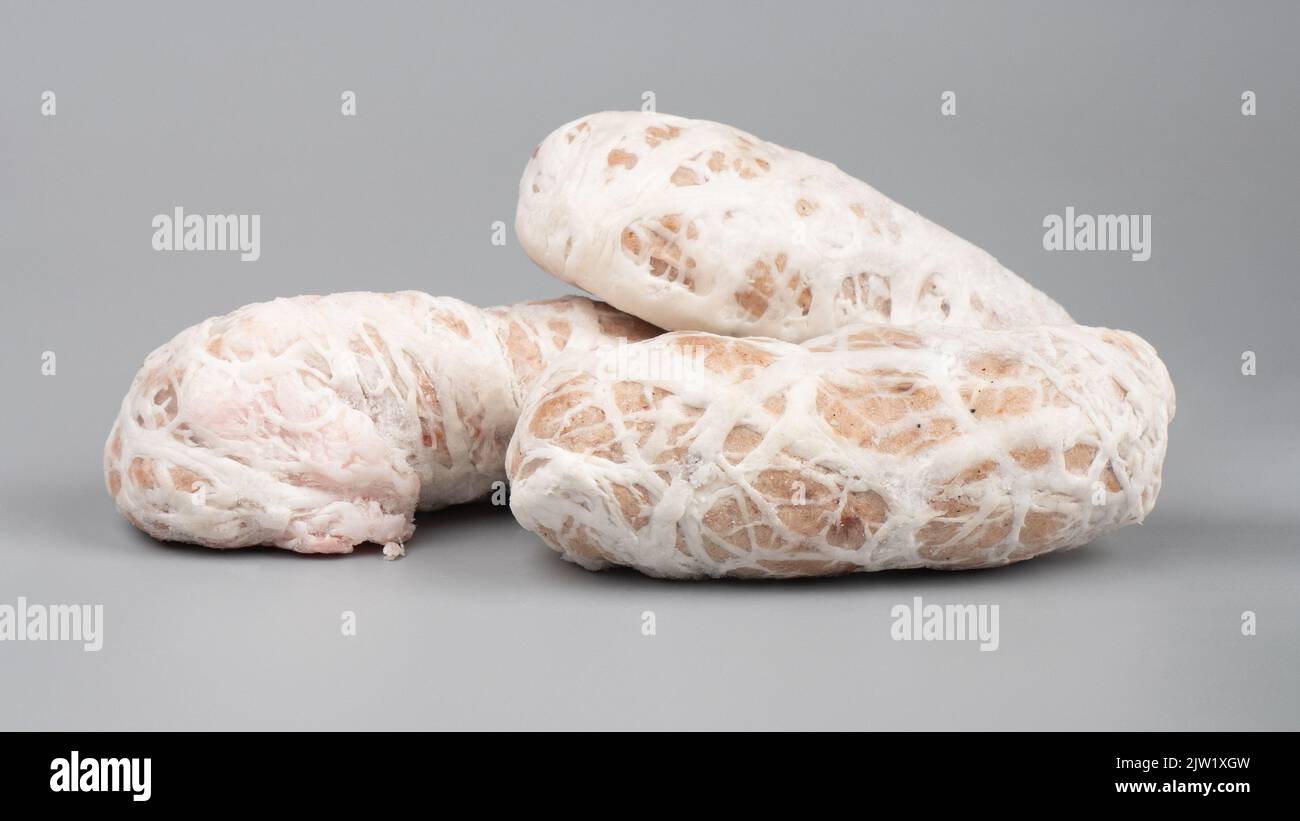 raw cutlet meatballs in pork intestine on gray background Stock Photo ...