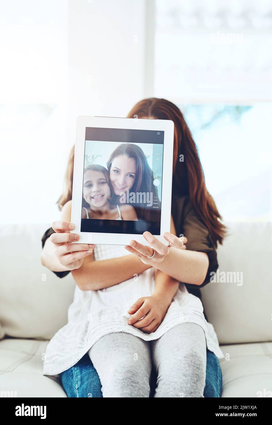 Making digital memories with mom. a little girl and her mother using a ...